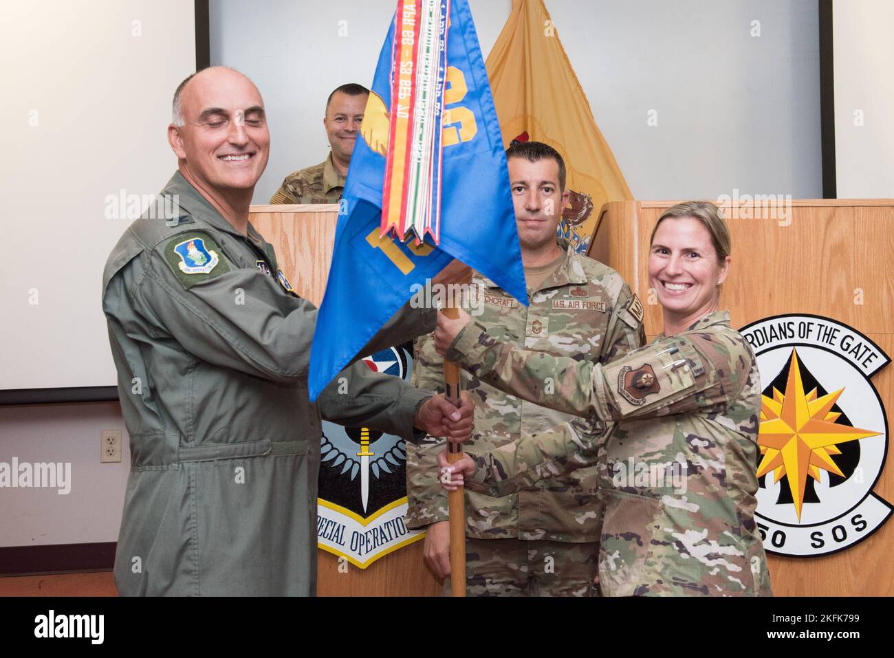 Col. William Liess, 108th Operations Group commander, left, passes the ...