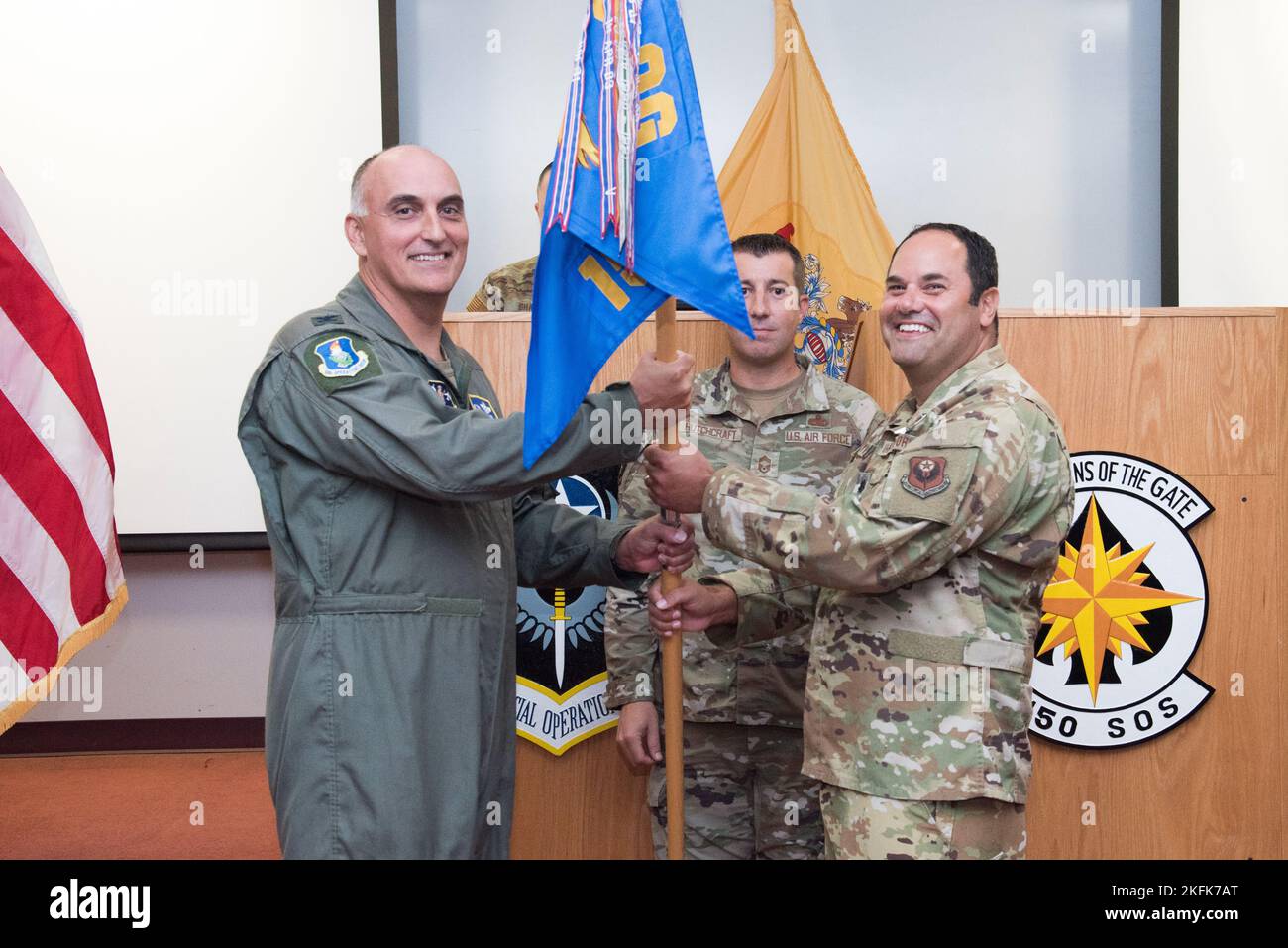 Col. William Liess, 108th Operations Group commander, left, receives ...