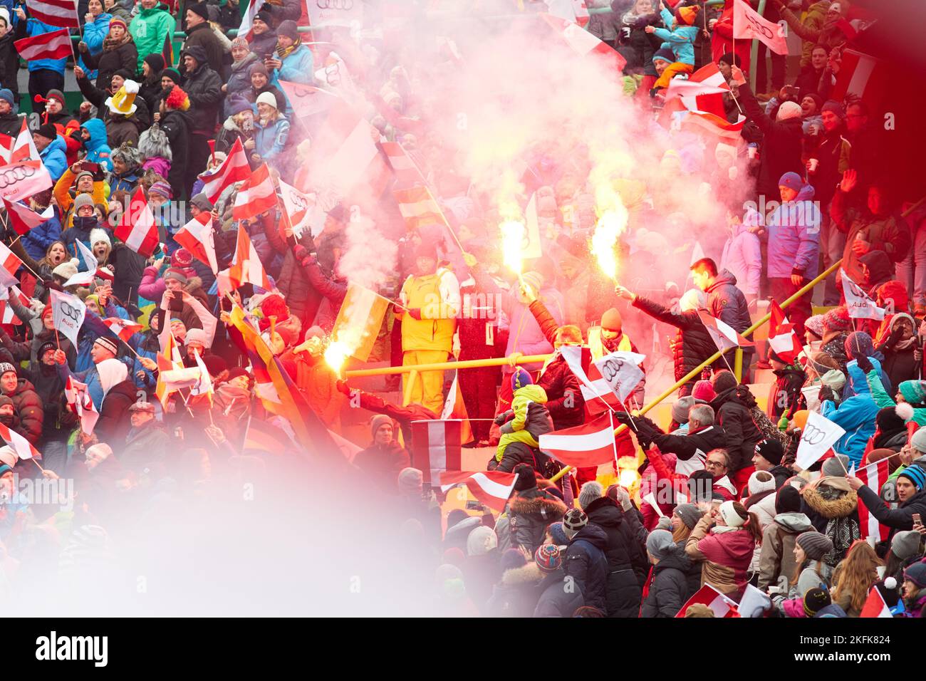 A view of the crowd with fires and flags at Vierschanzentournee in ...
