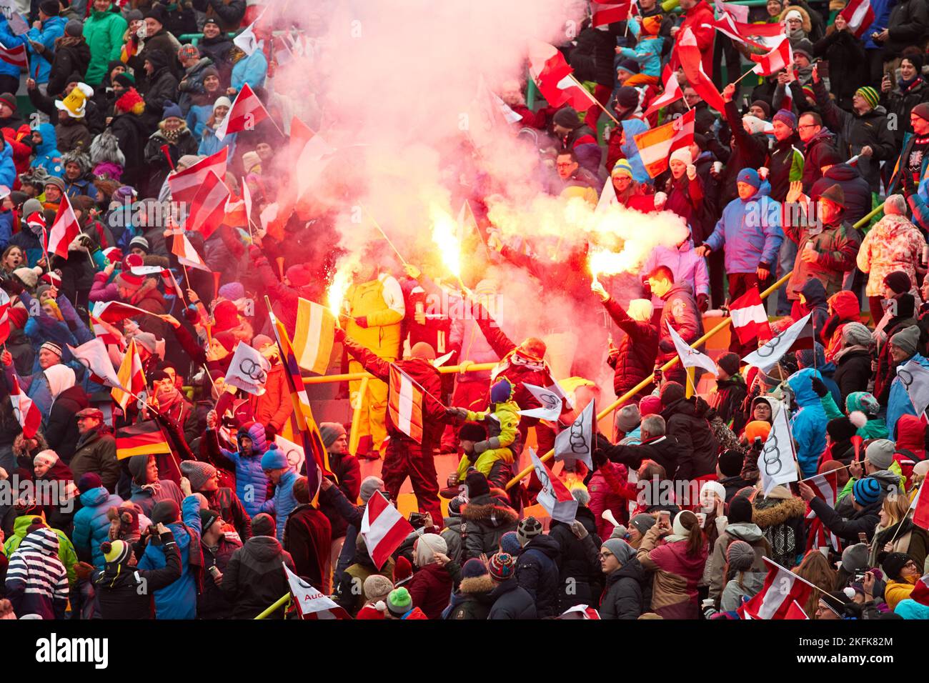 A view of the crowd with fires and flags at Vierschanzentournee in ...