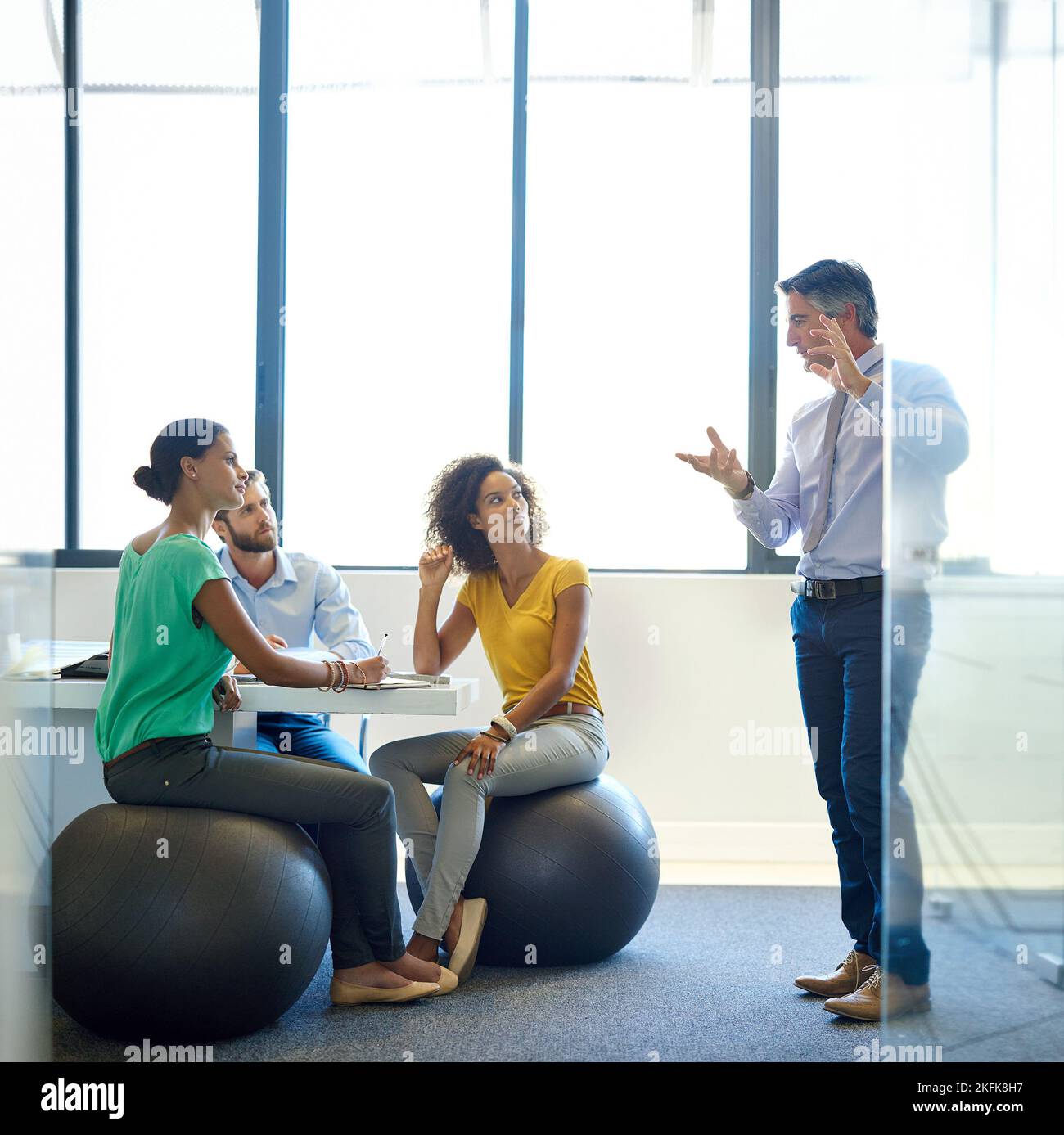Getting his ideas across. Full length shot of a business meeting in ...