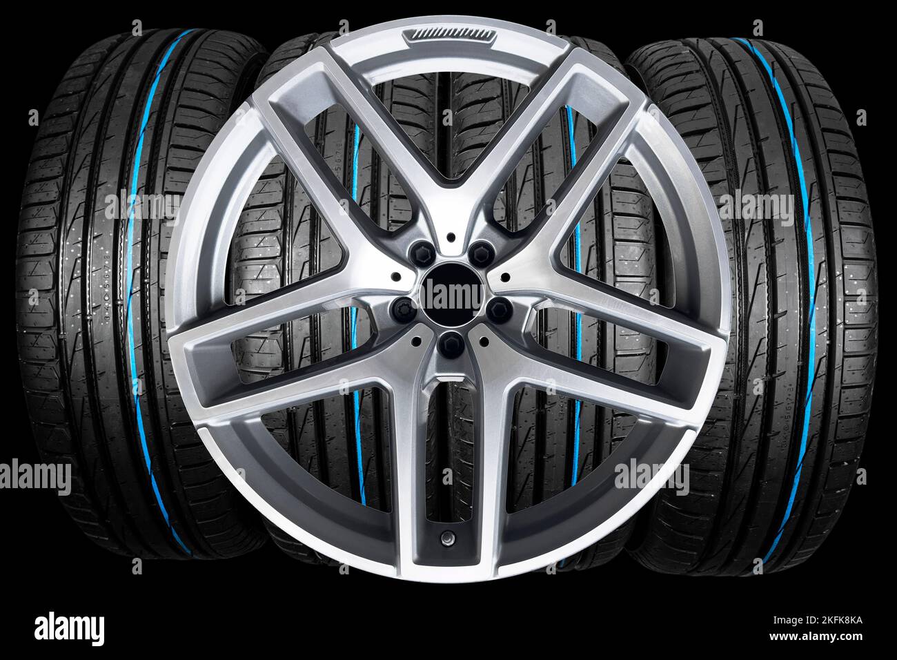 Car alloy wheel and tyre isolated on black background. New alloy wheel ...