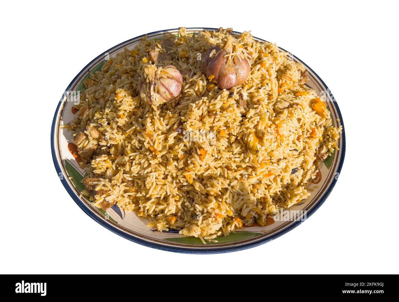 Pilaf with meat on plate isolated on white background. Uzbek pilaf ...