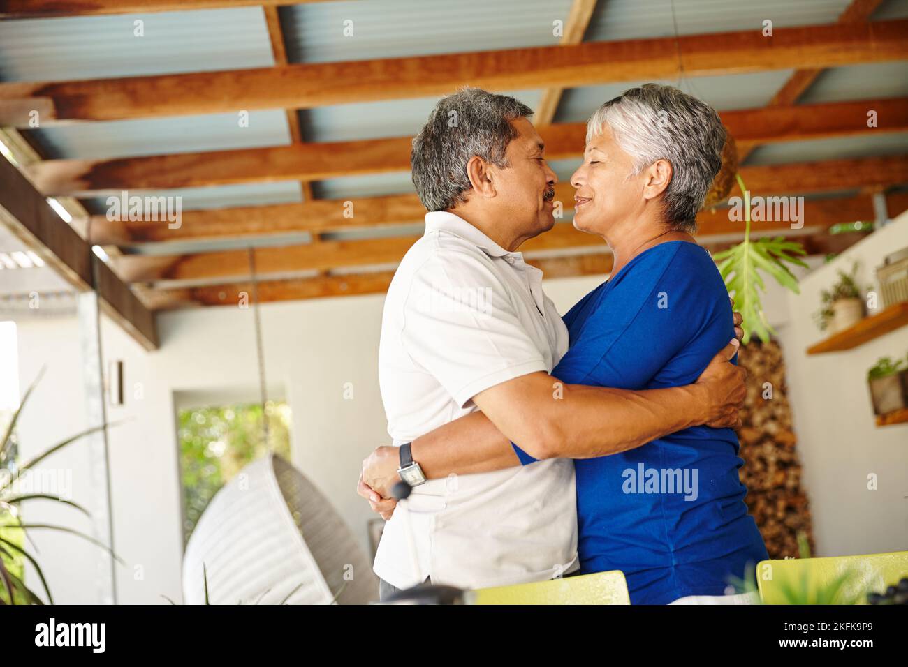 I love you honey. a happy senior couple wrapped in a warm embrace at ...