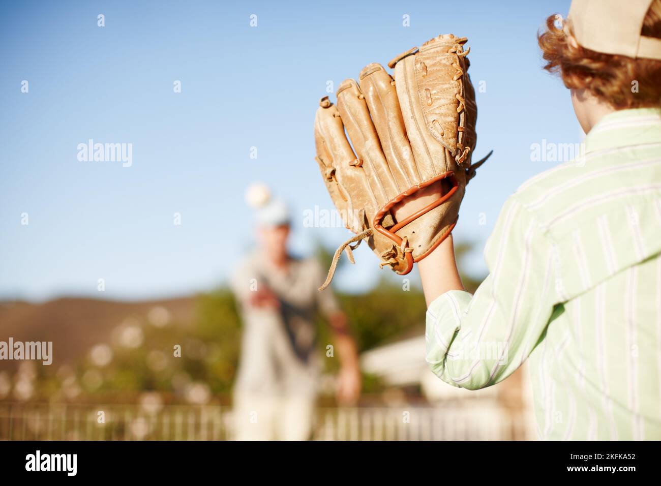 Playing catch in the yard. a father and son throwing the baseball ...