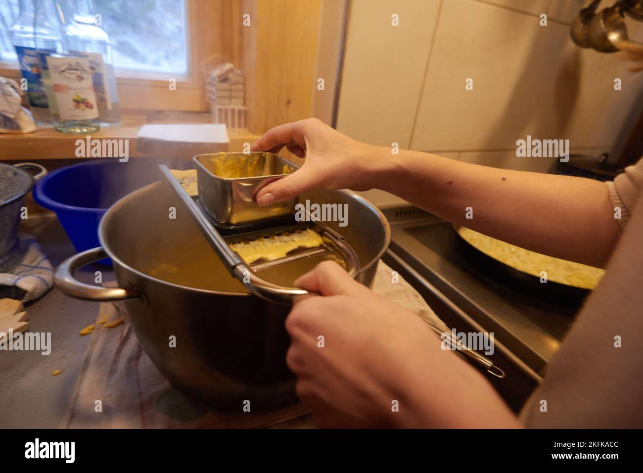 A female grating butter into the boiling water Stock Photo - Alamy