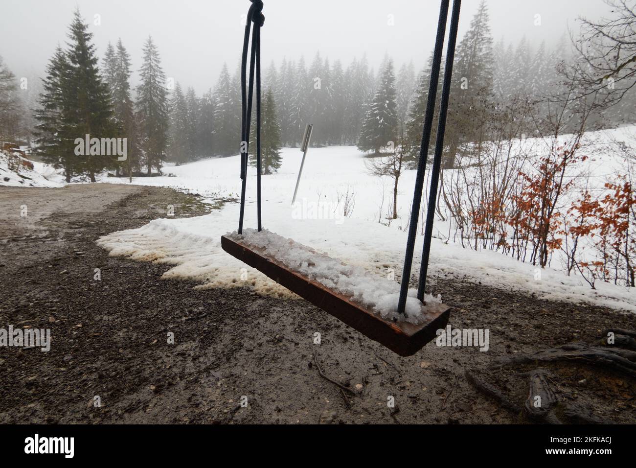 A closeup of a wooden swing covered with snow in a garden Stock Photo ...