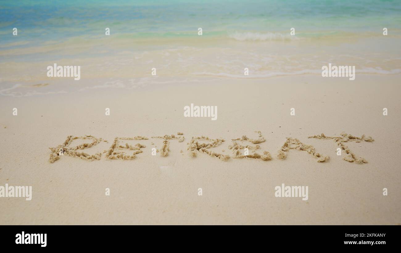 Retreat Text Written On Sand Near The Idyllic Sea At Beach Stock Photo ...