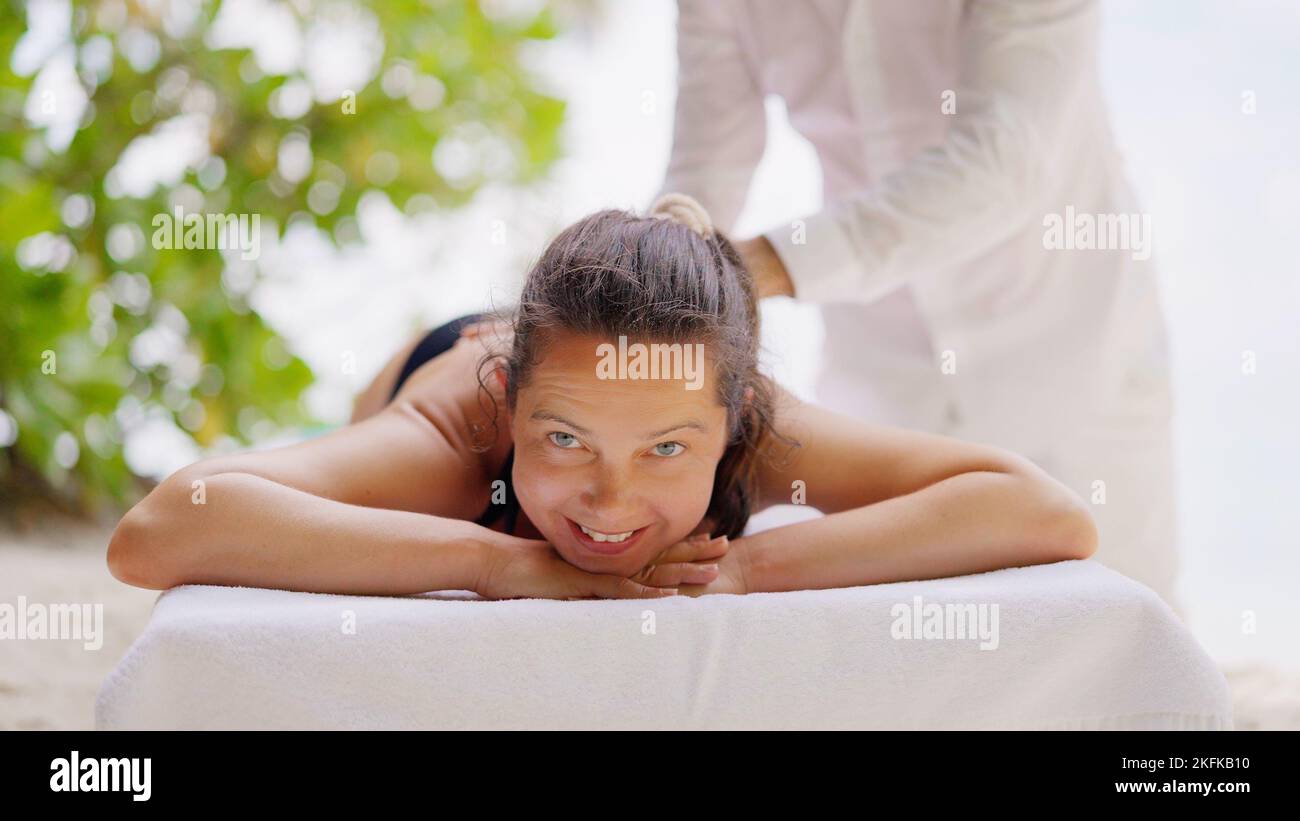 Female Back Treatment Therapy On Beach. Young Woman Body Care Stock Photo - Alamy