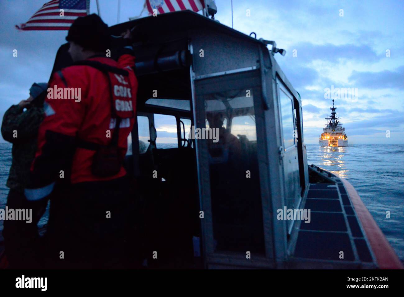 Crewmembers aboard a Long-Range Interceptor (LRI) cutter boat approach ...