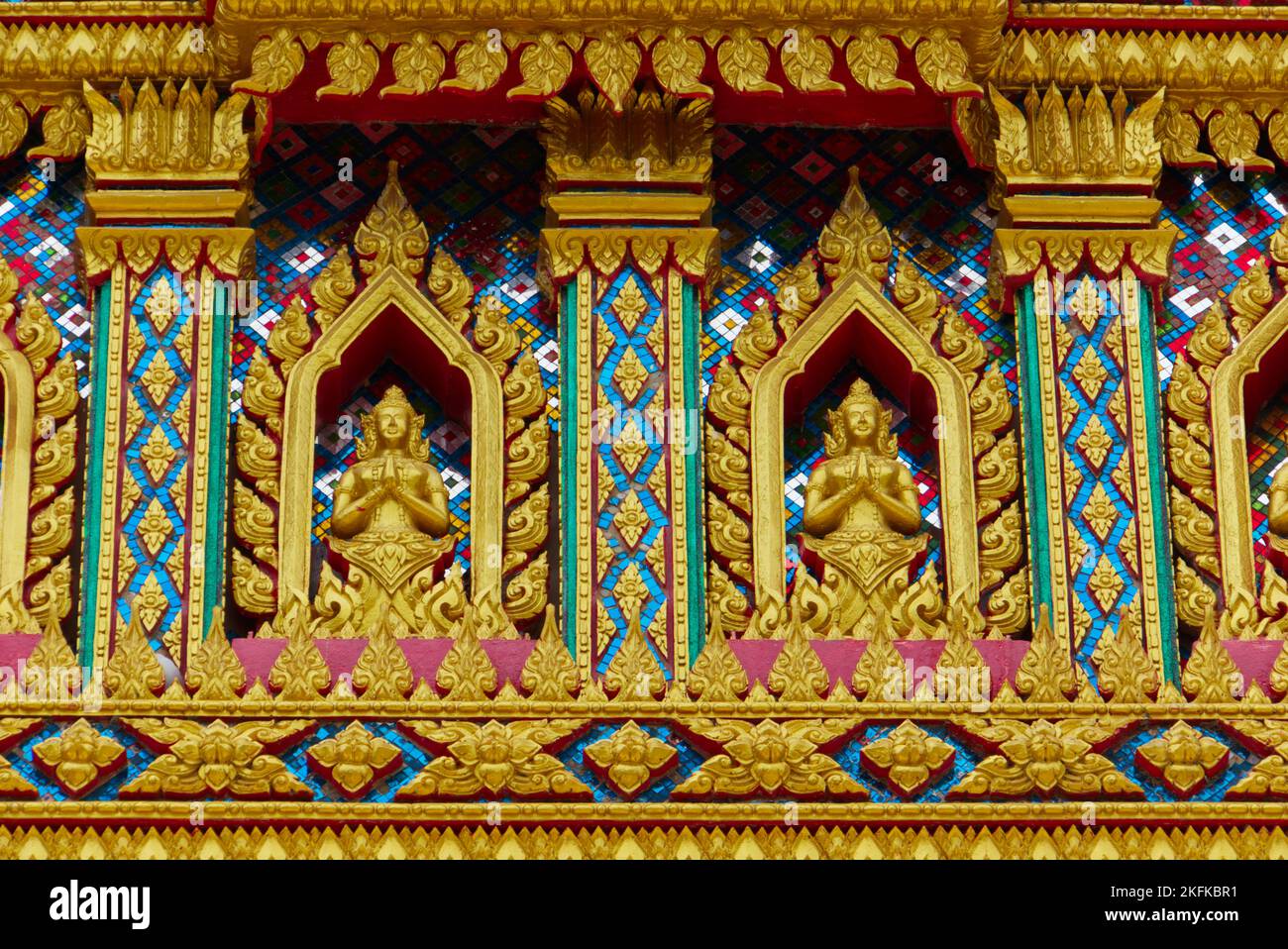 Thailand temple detail view with abstract colours and gold leaf texture ...