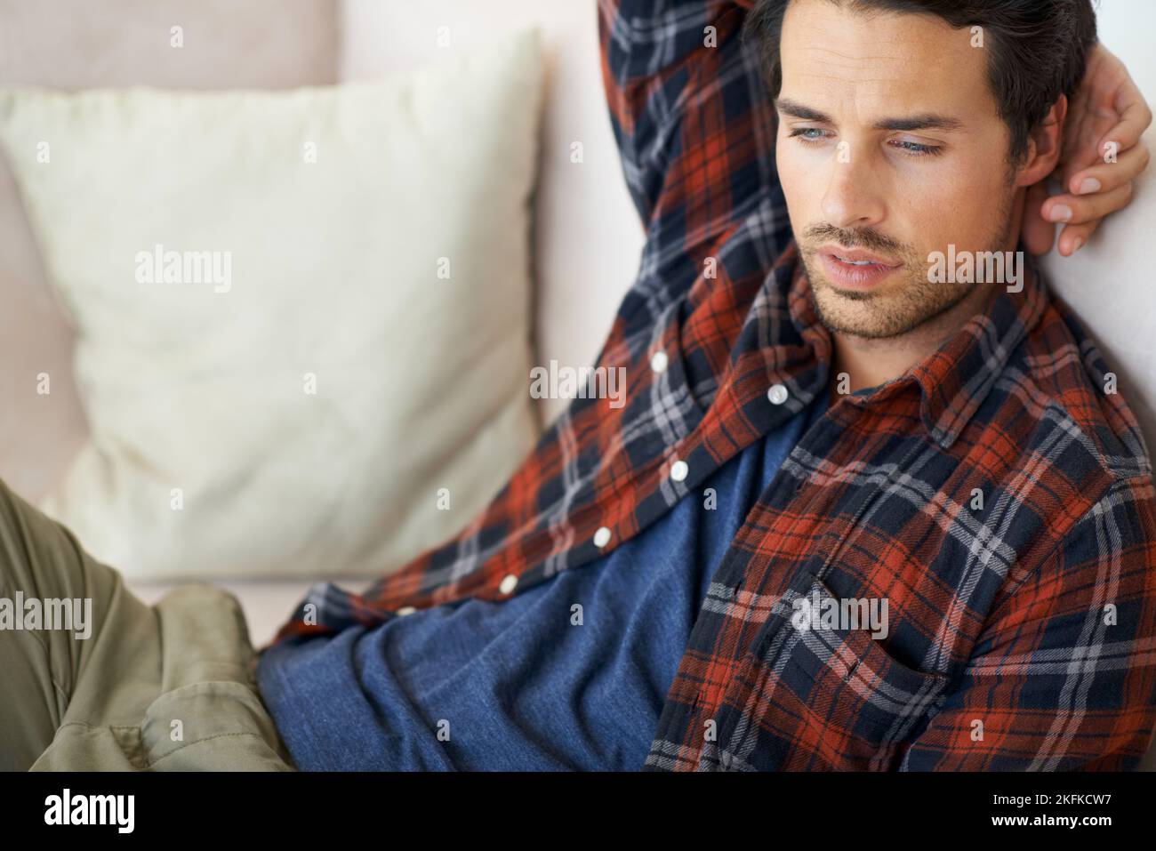 Hes having a laid back day at home. A gorgeous young man lying on a ...