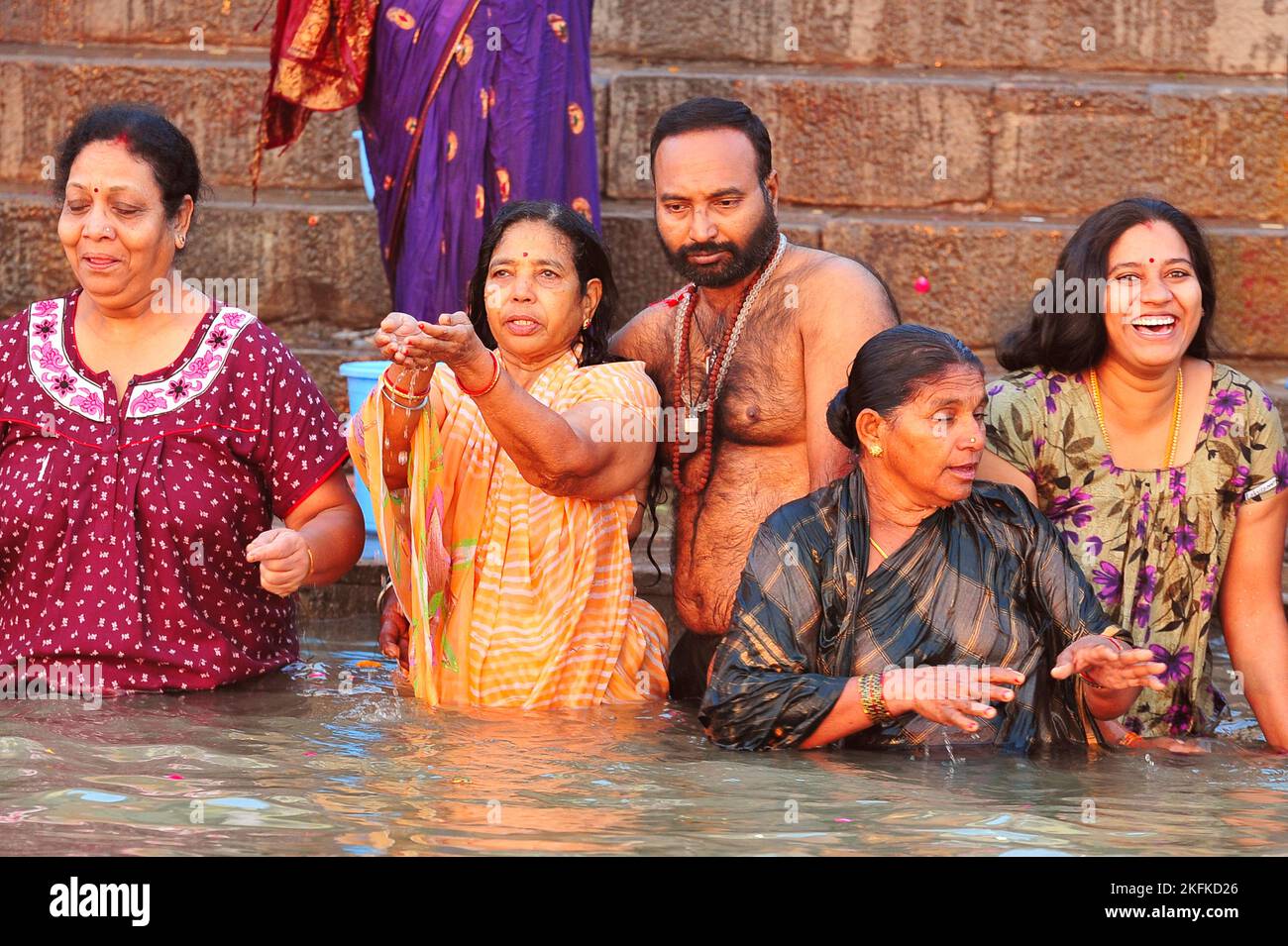 Pilgrims bathing in the Ganges river at sunset Stock Photo - Alamy