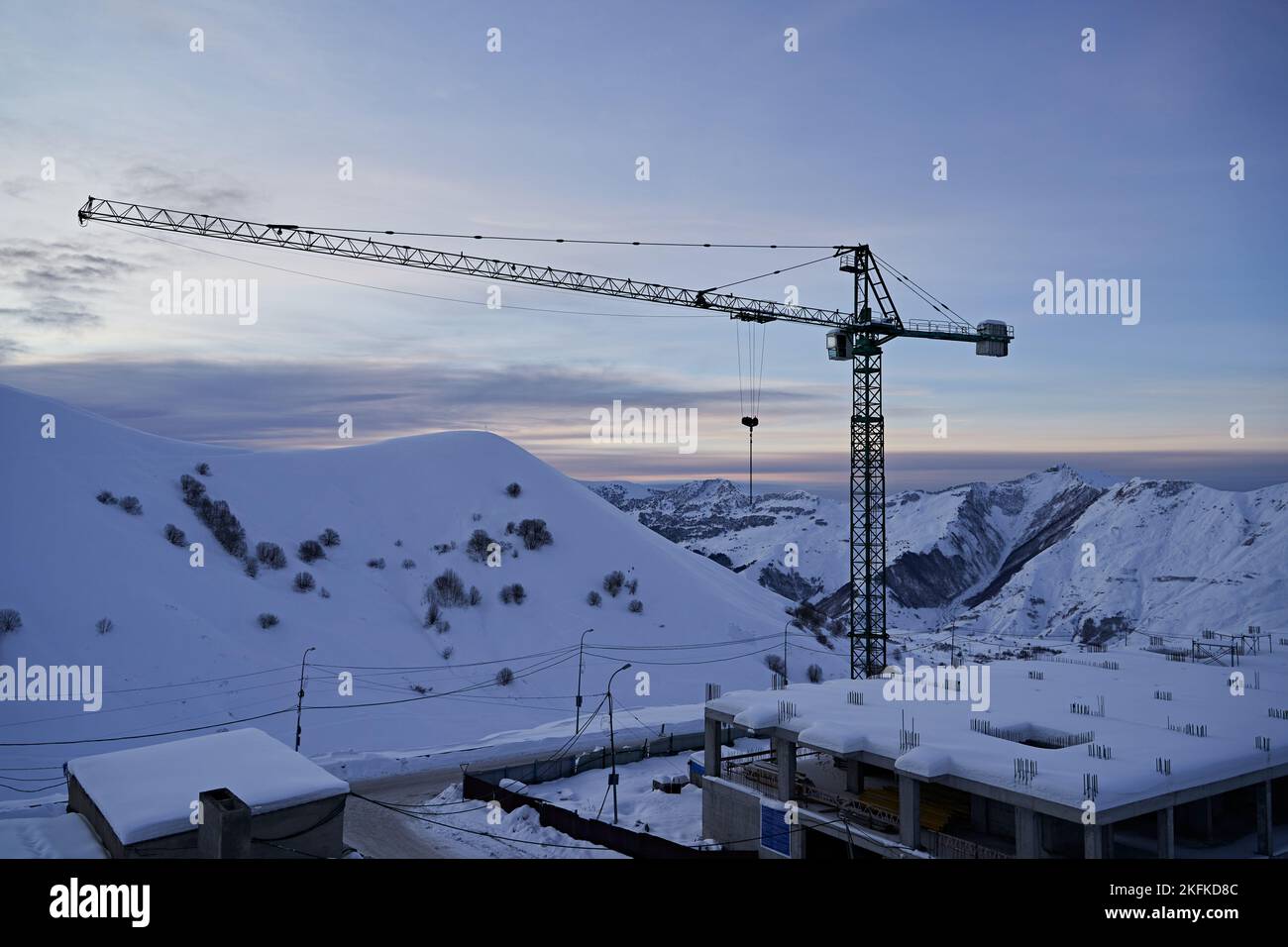 Construction site of ski resort hotel chalet framework and crane with ...