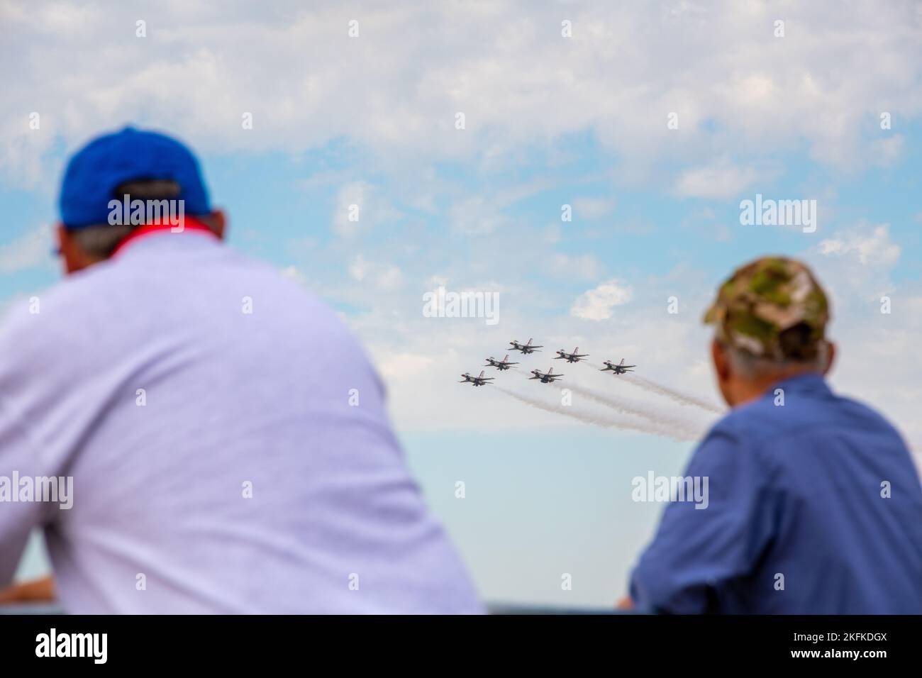 Spectators watch the USAF Thunderbirds perform aerial maneuvers during ...