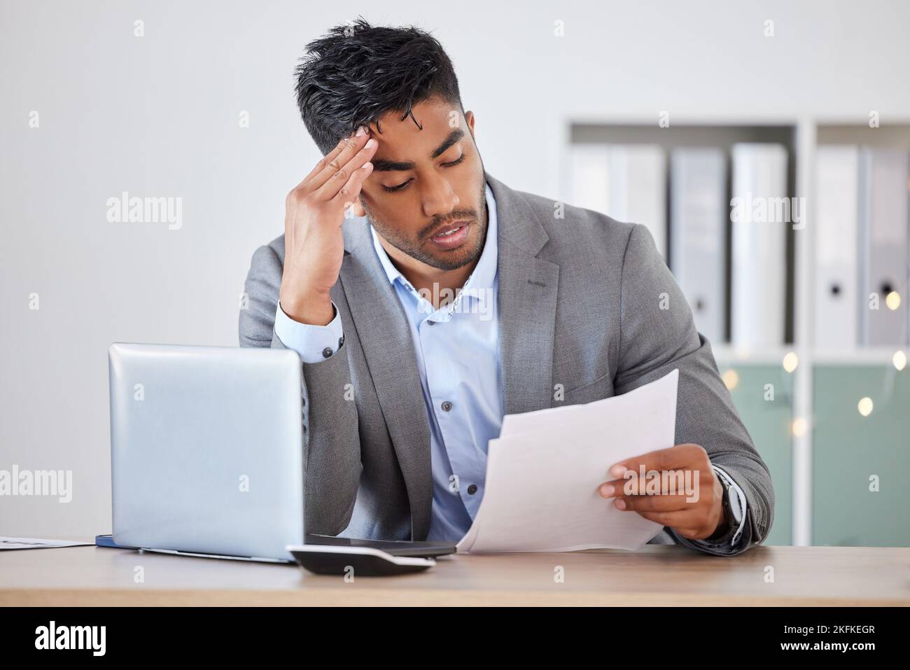 Businessman, laptop and stress with budget, paper and headache. for ...