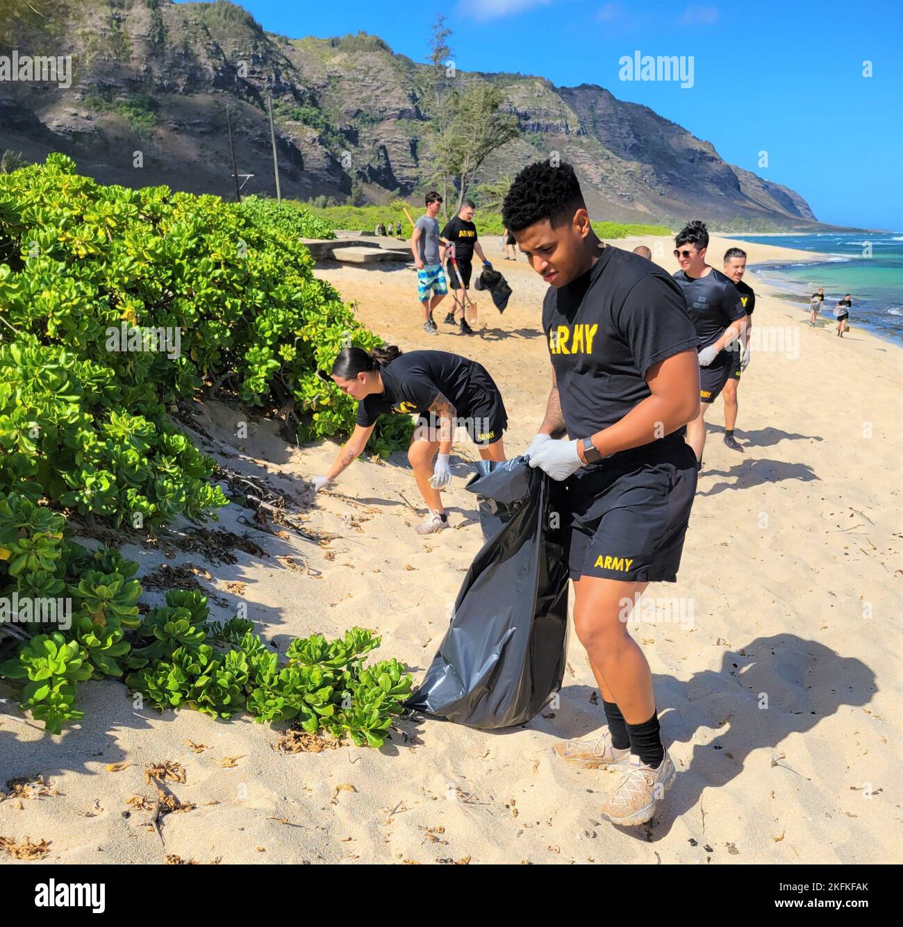 8th Military Police Brigade Soldiers load trash bags full of litter and ...