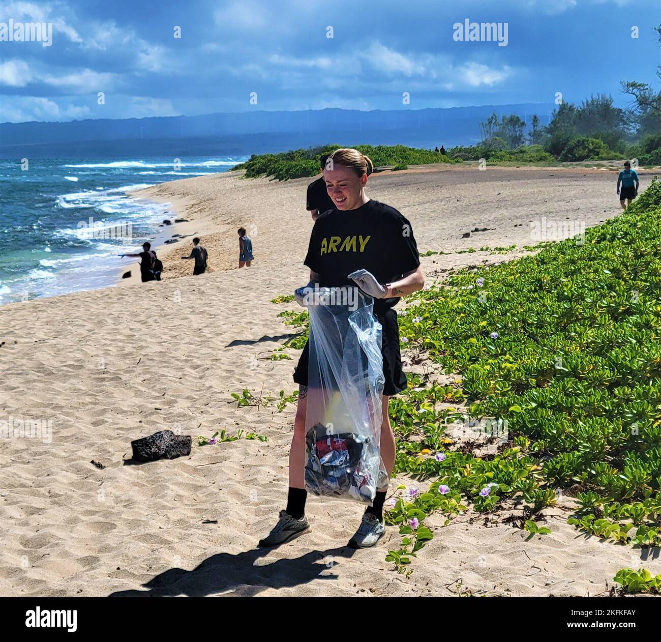 8th Military Police Brigade Soldiers load trash bags full of litter and ...