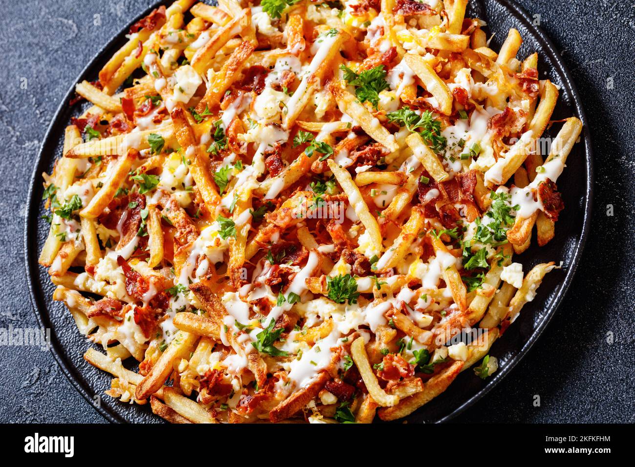 close-up of Bacon Mozzarella Feta Cheddar Cheese Fries with ranch ...