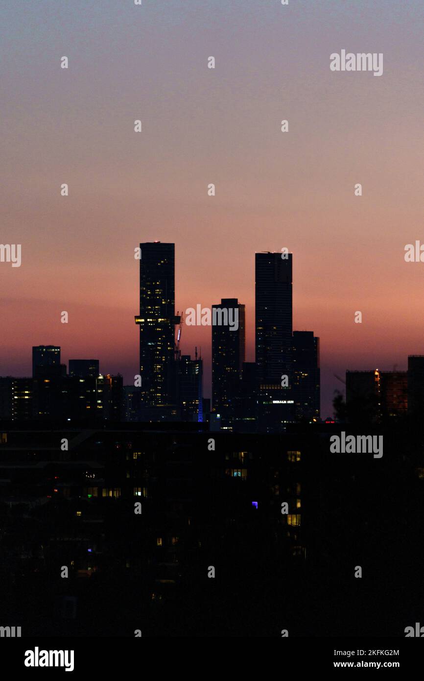 A vertical aerial view of Melbourne cityscape at dusk with silhouettes ...