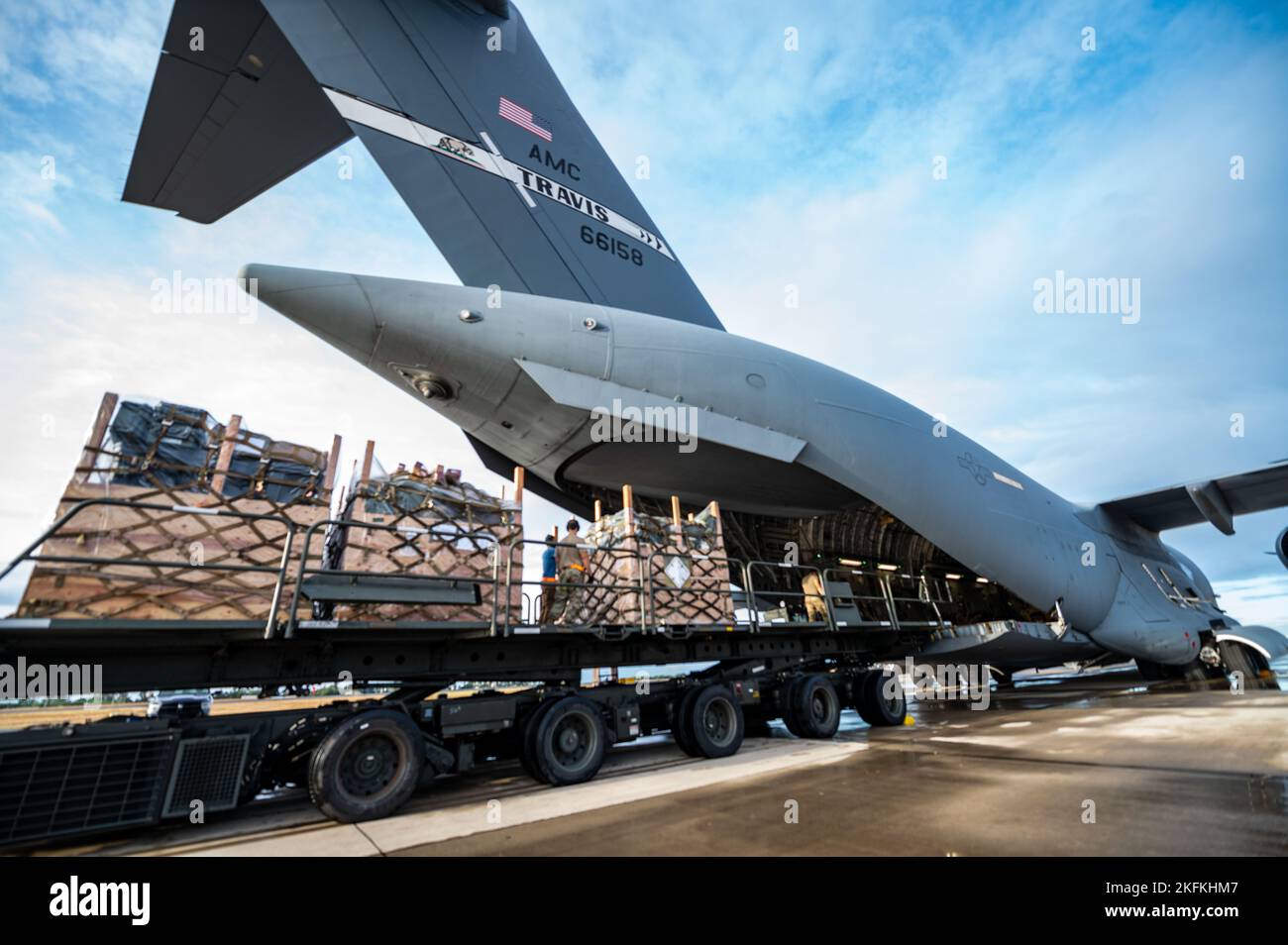 U.S. Airmen assigned to the 21st Airlift Squadron load 39,000 pounds of ...