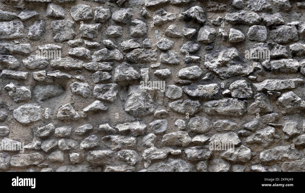 BACKGROUND TEXTURE - Wall constructed of irregular shaped dark stones ...
