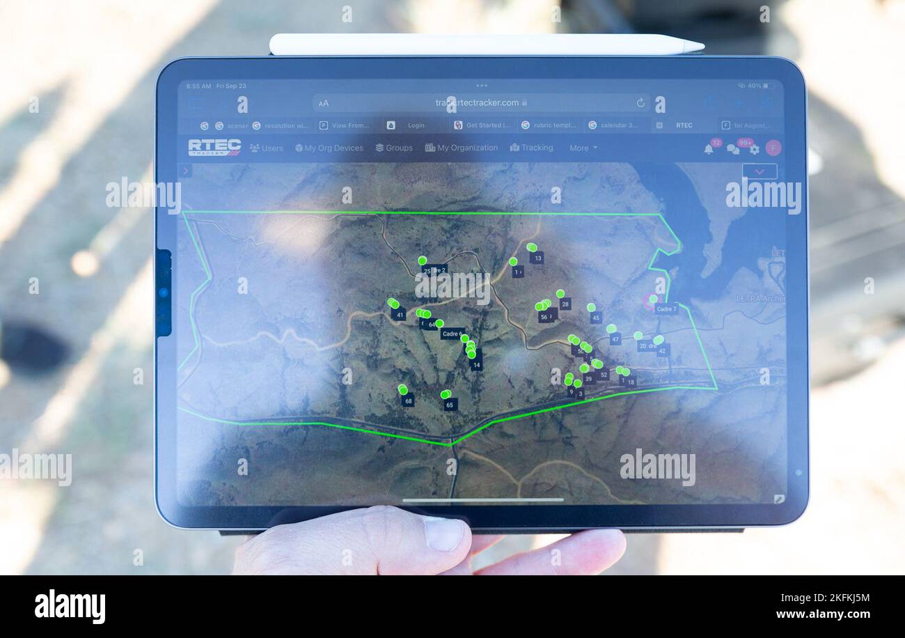 A cadre member shows the training area map and real-time student ...