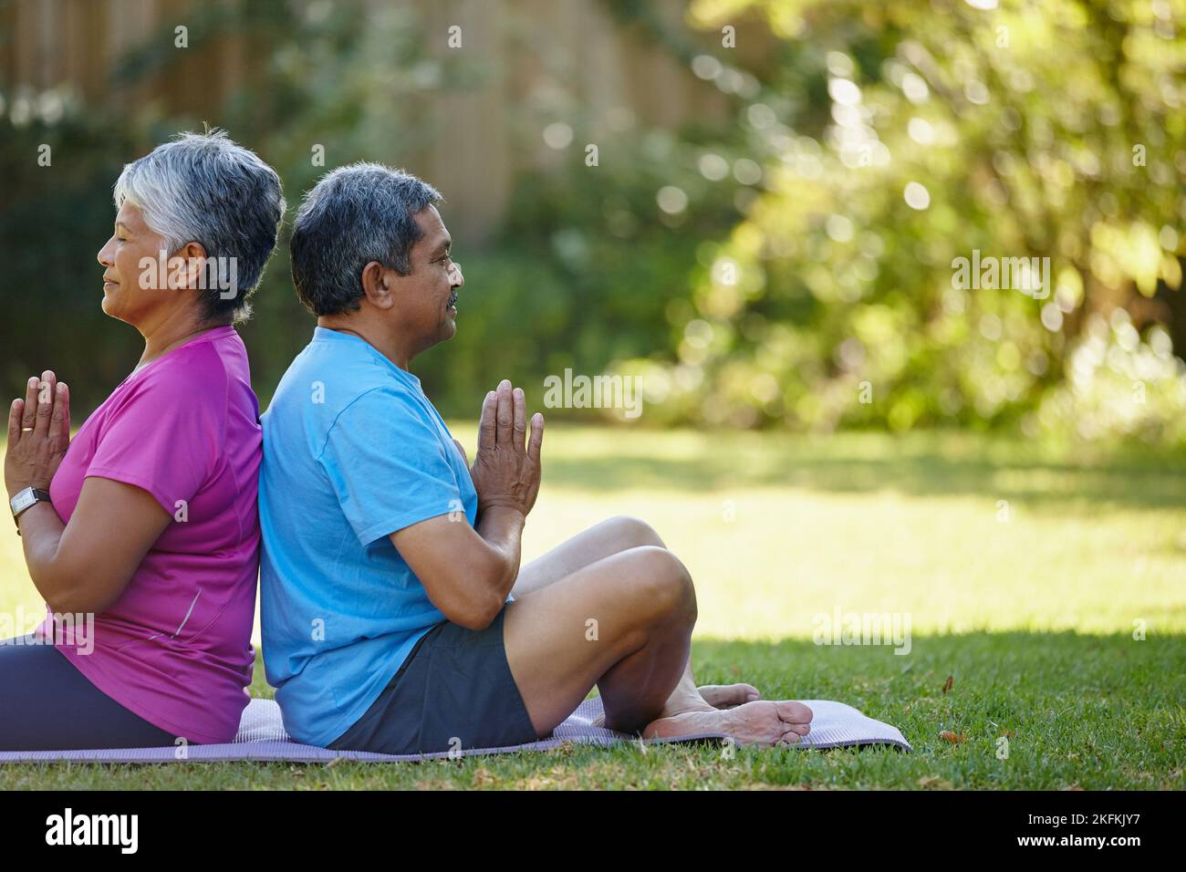 Keeping balanced and healthy. a mature couple doing yoga together in ...