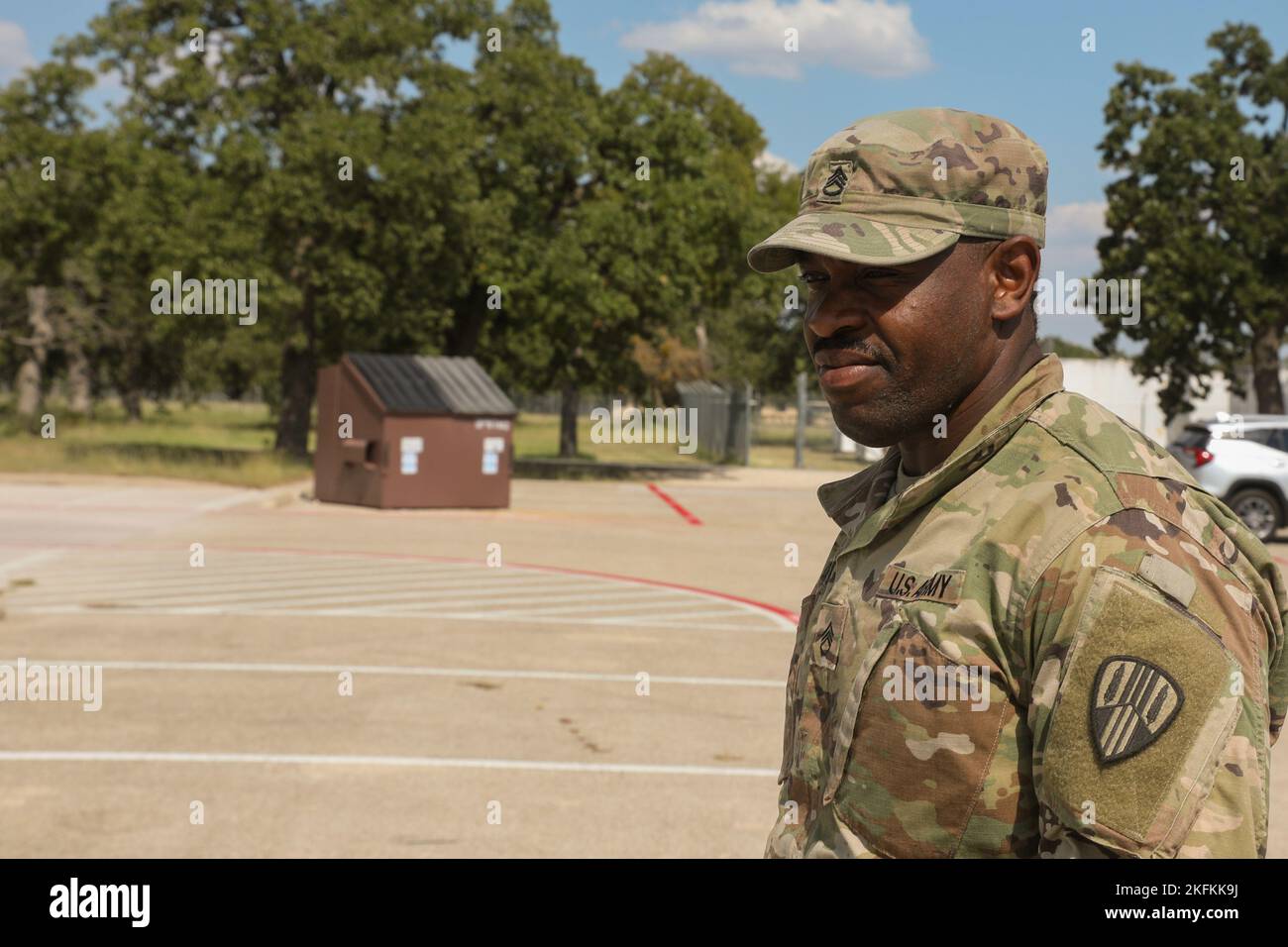 U.S. Army Staff Sgt. Kimani George walks in the vicinity of the white ...