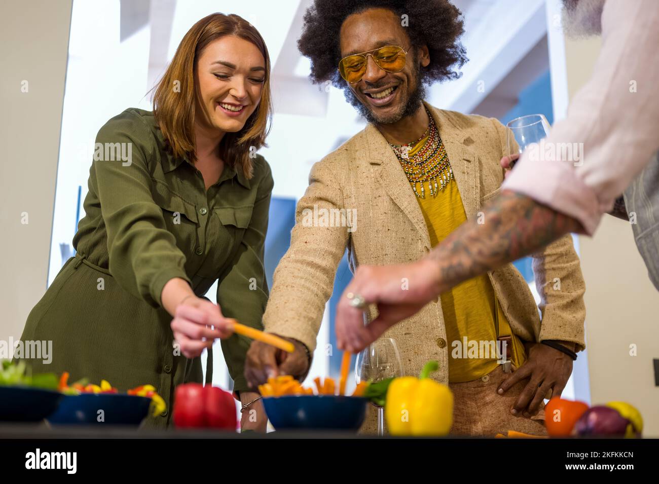 people eating vegan buffet, multiracial group of friends having fun at ...