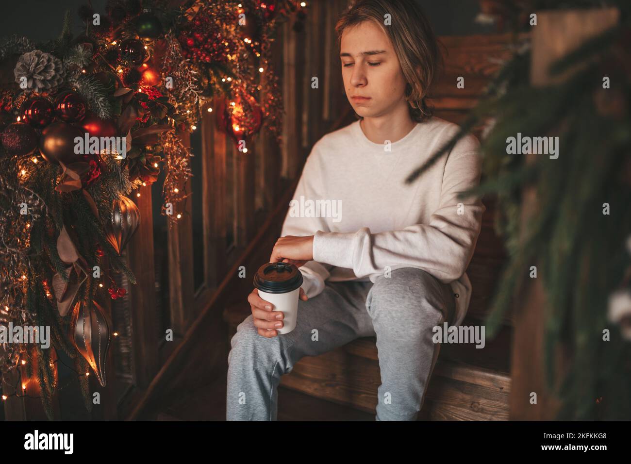 Young teen boy with long hair thoughtful look sad eyes negative mood ...