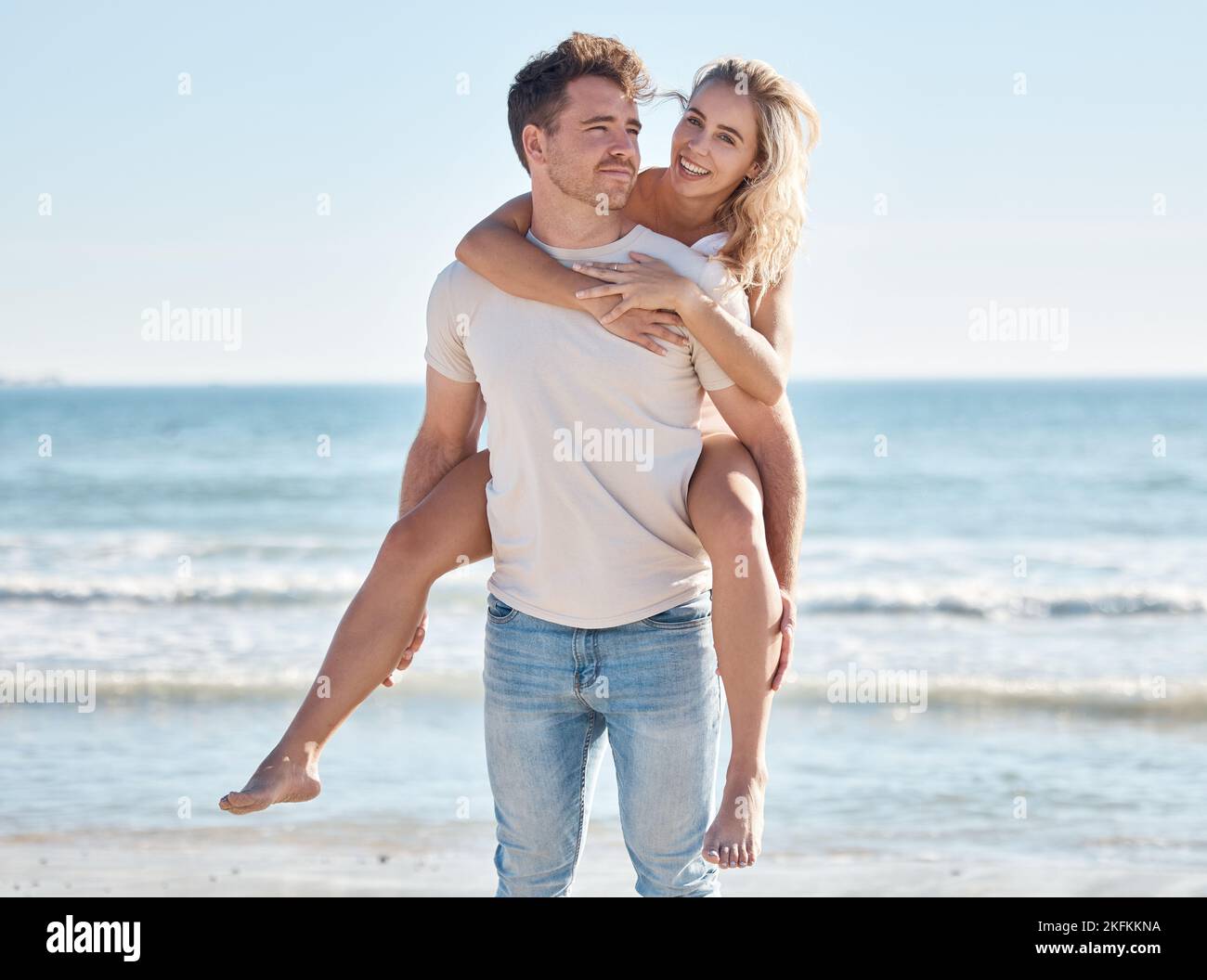 Love, summer and couple doing piggyback at the beach enjoying romantic ...