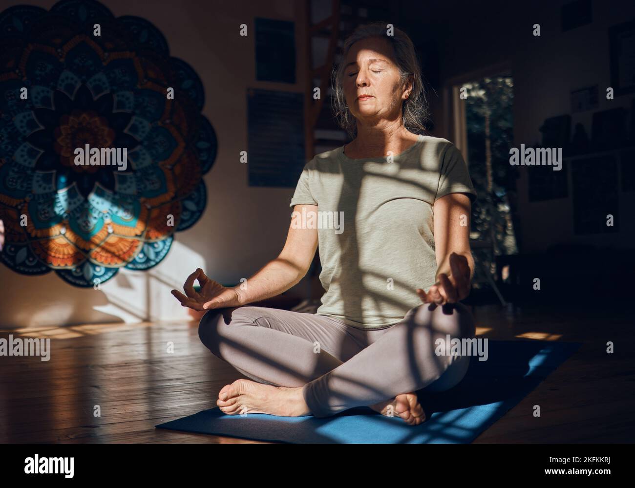 Yoga, prayer hands and meditation of senior woman in dark house for ...