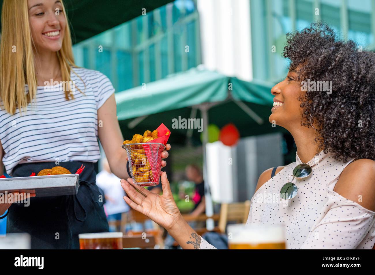 serving delicious snacks to a client, African American woman at the ...