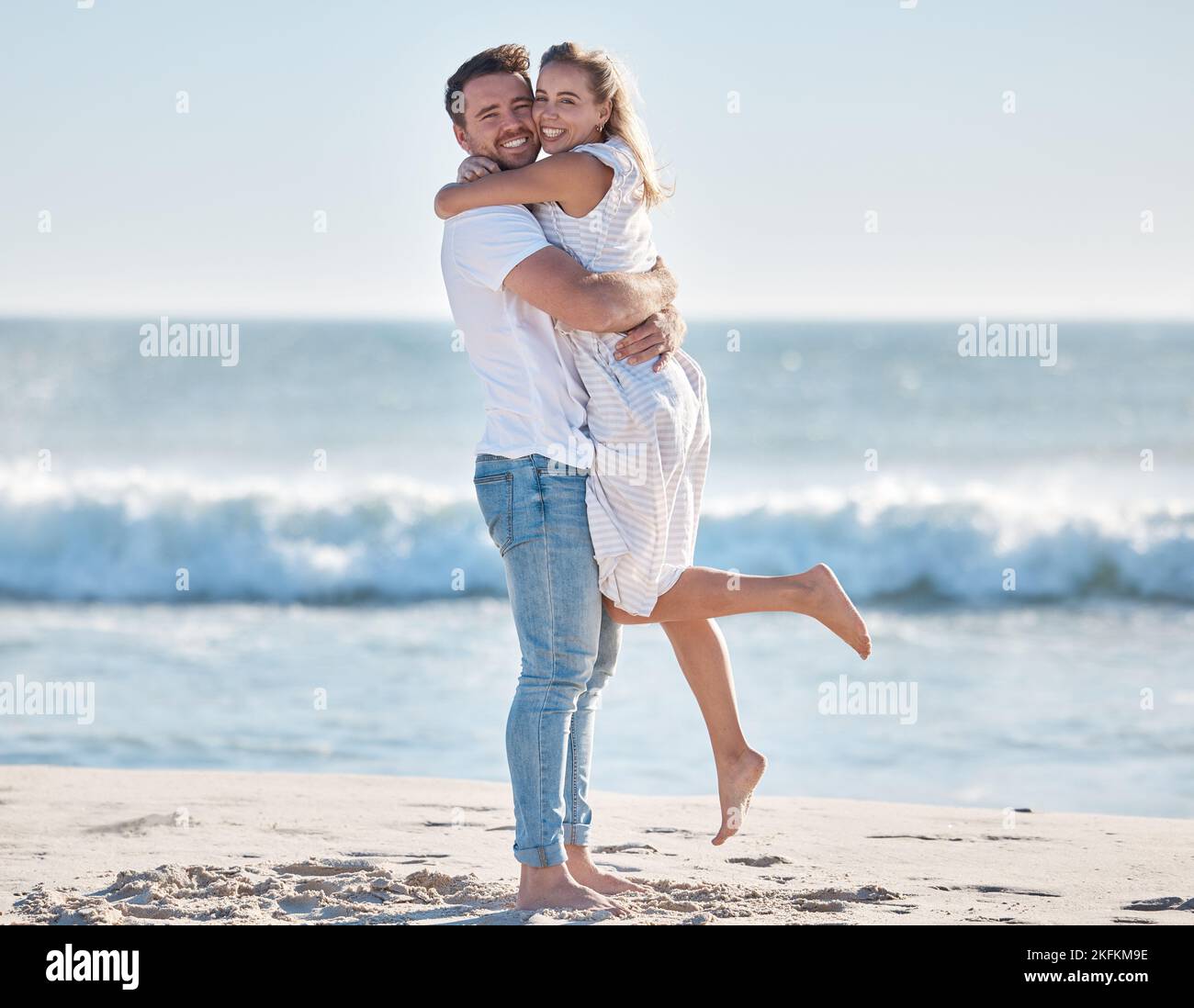 Hug, happy and couple at the beach for love, peace and relax on a ...