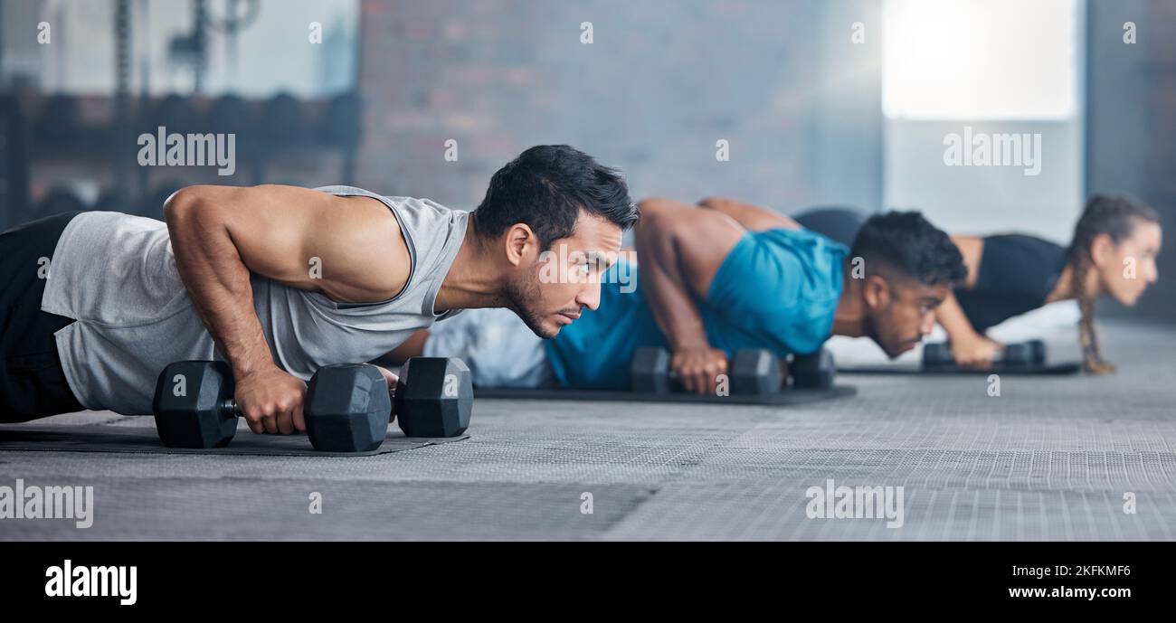 Men, woman and dumbbells in gym workout, training and fitness exercise ...