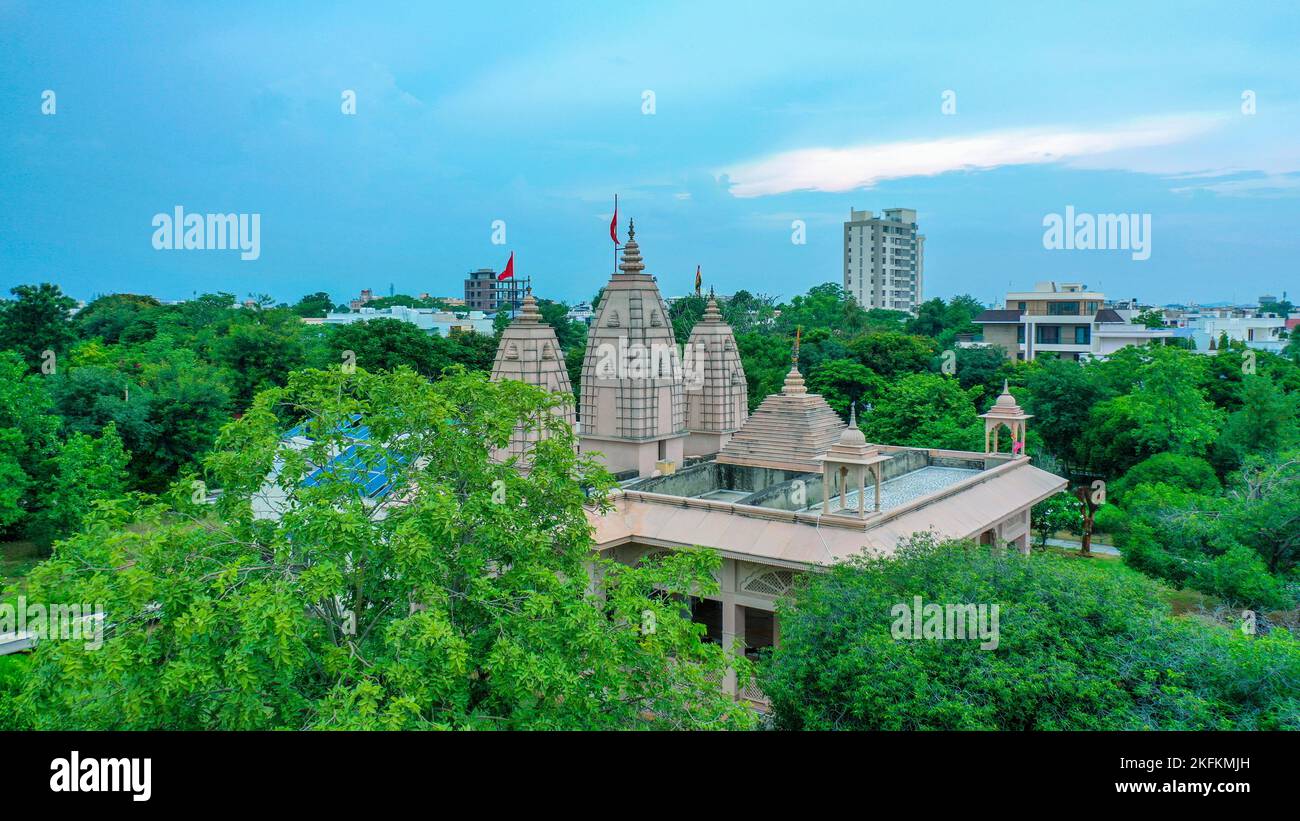 A beautiful ancient Indian jain temple surrounded by green trees in ...