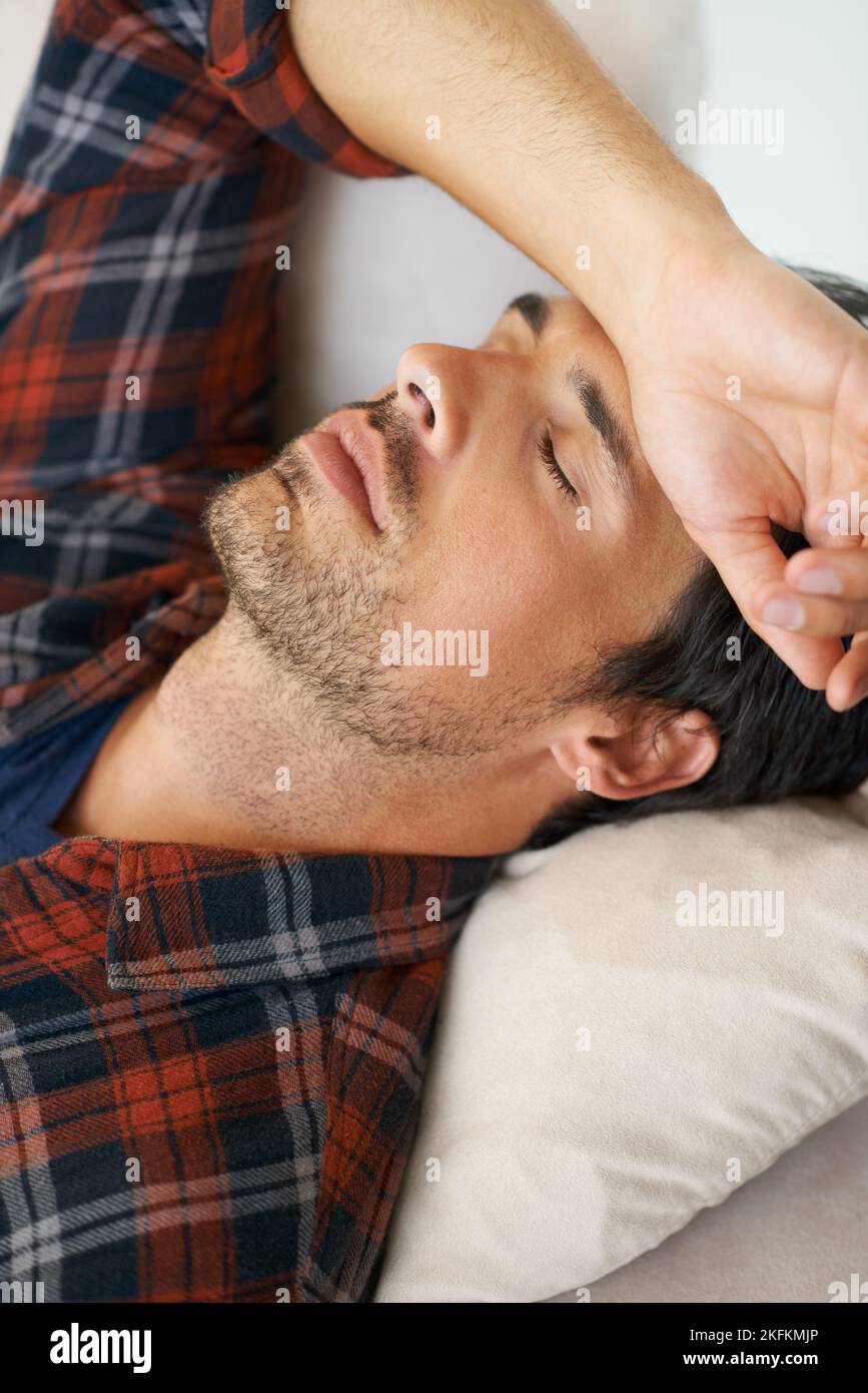 Collapsing under the pressure. A gorgeous young man lying down with his ...