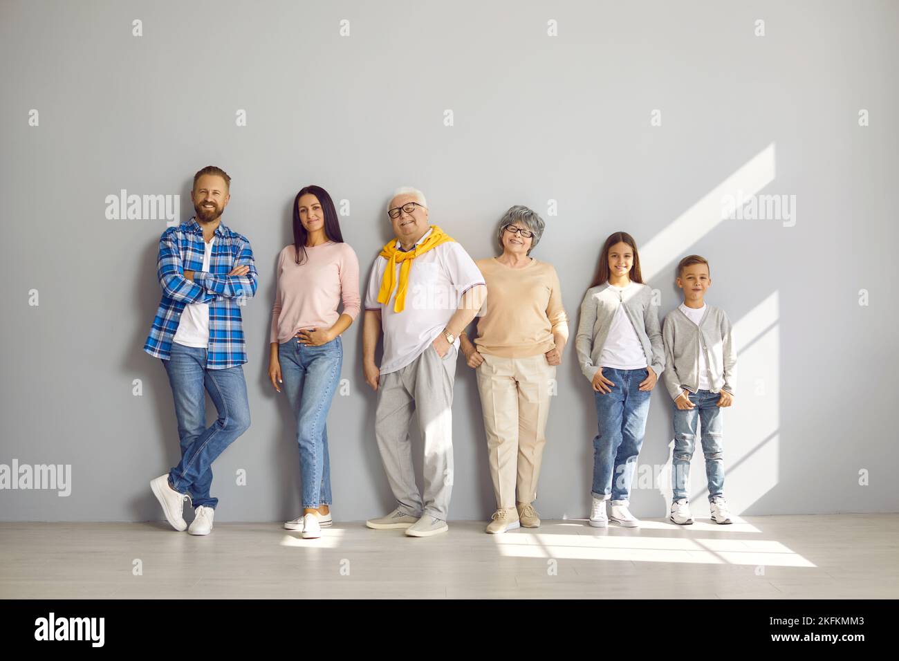 Portrait of happy family consisting of three generations standing in ...