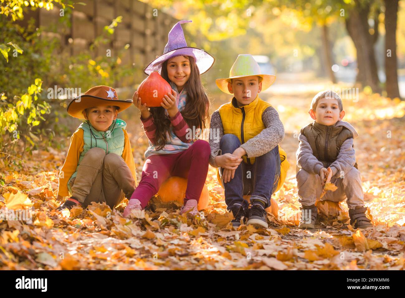 Group of little kids enjoying harvest festival celebration at pumpkin ...