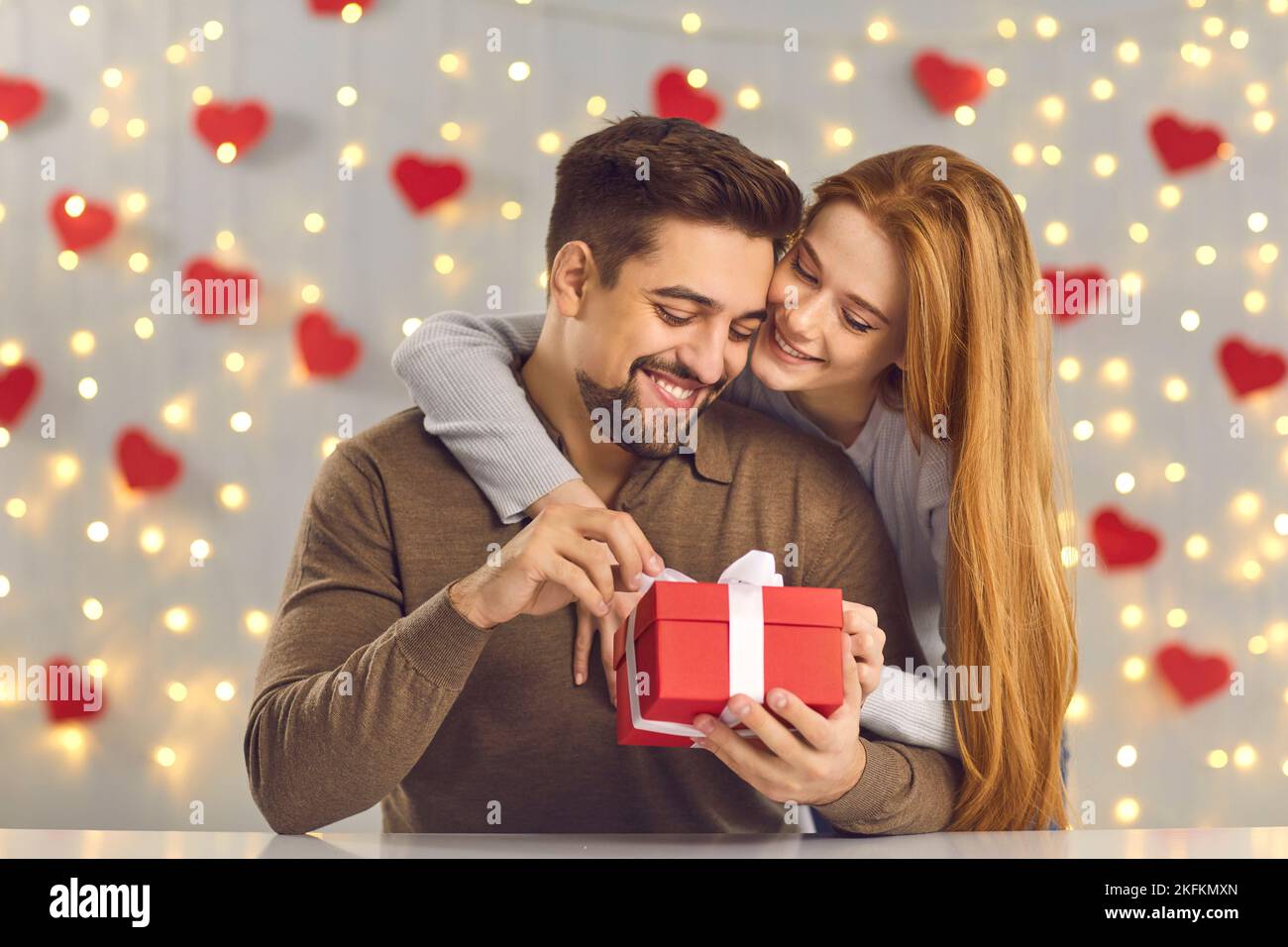 Extremely happy young woman is worried and hugs her husband tightly ...