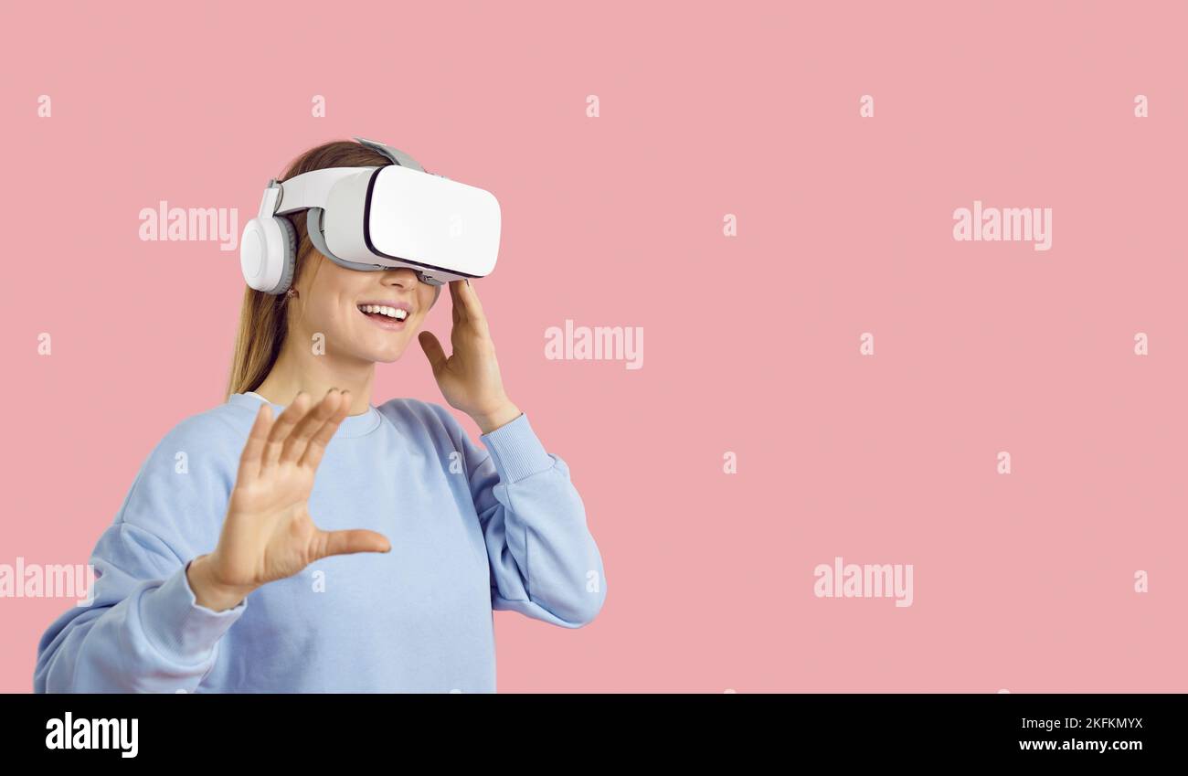 Happy girl on copy space background experiencing virtual reality in her ...