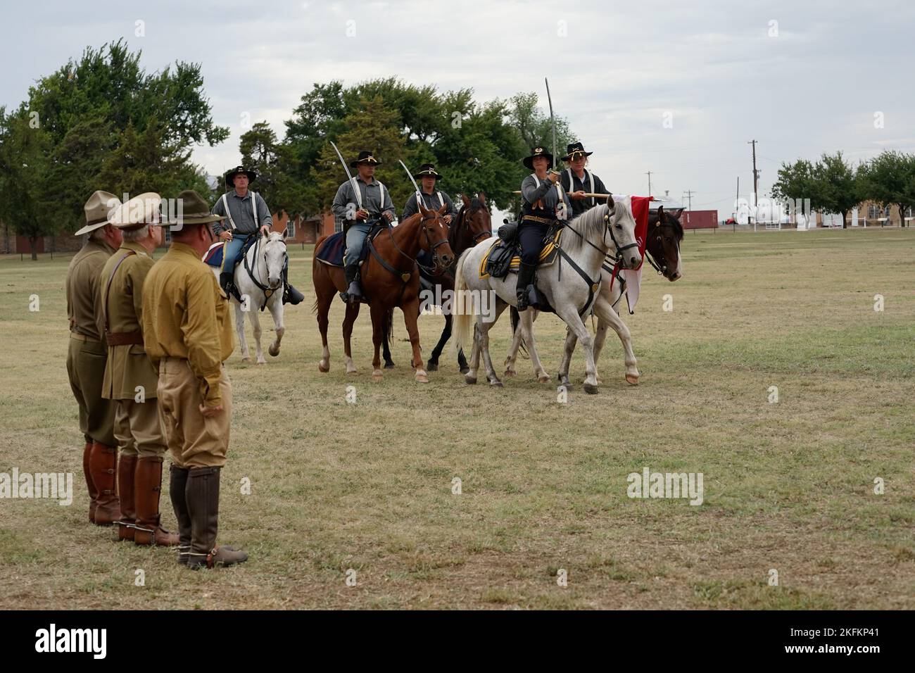 The Fort Carson Mountain Color Guard (FCMCG), marches through the field on their horses during ...