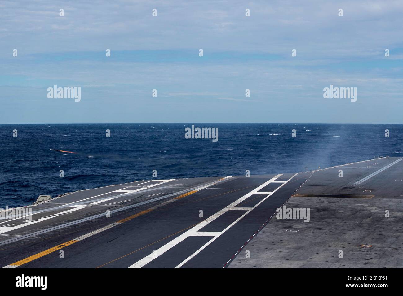 A rolling airframe missile (RAM) launcher fires a RIM-116 missile from ...