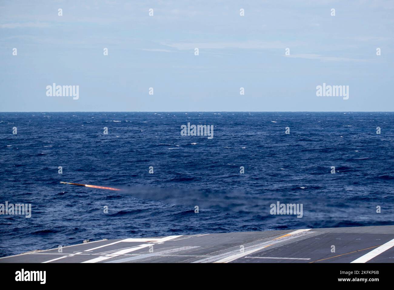 A rolling airframe missile (RAM) launcher fires a RIM-116 missile from ...