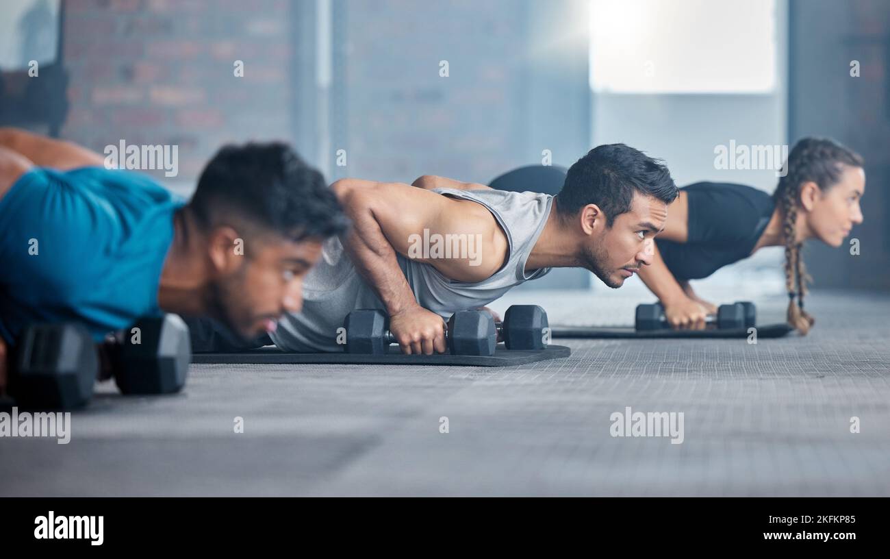 Fitness, exercise and gym with a personal trainer teaching or training ...