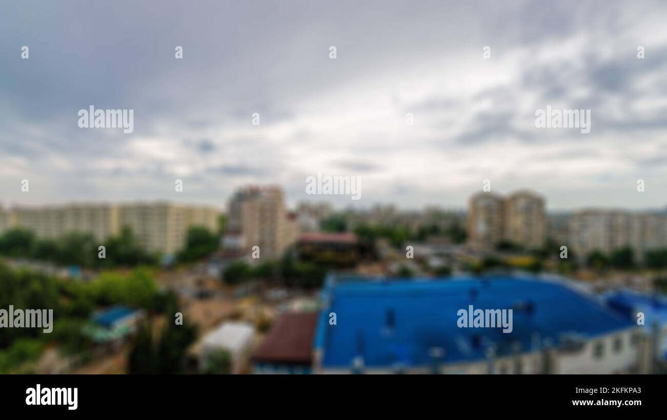 Abstract defocused city view with cloudy sky, view from high floor of ...