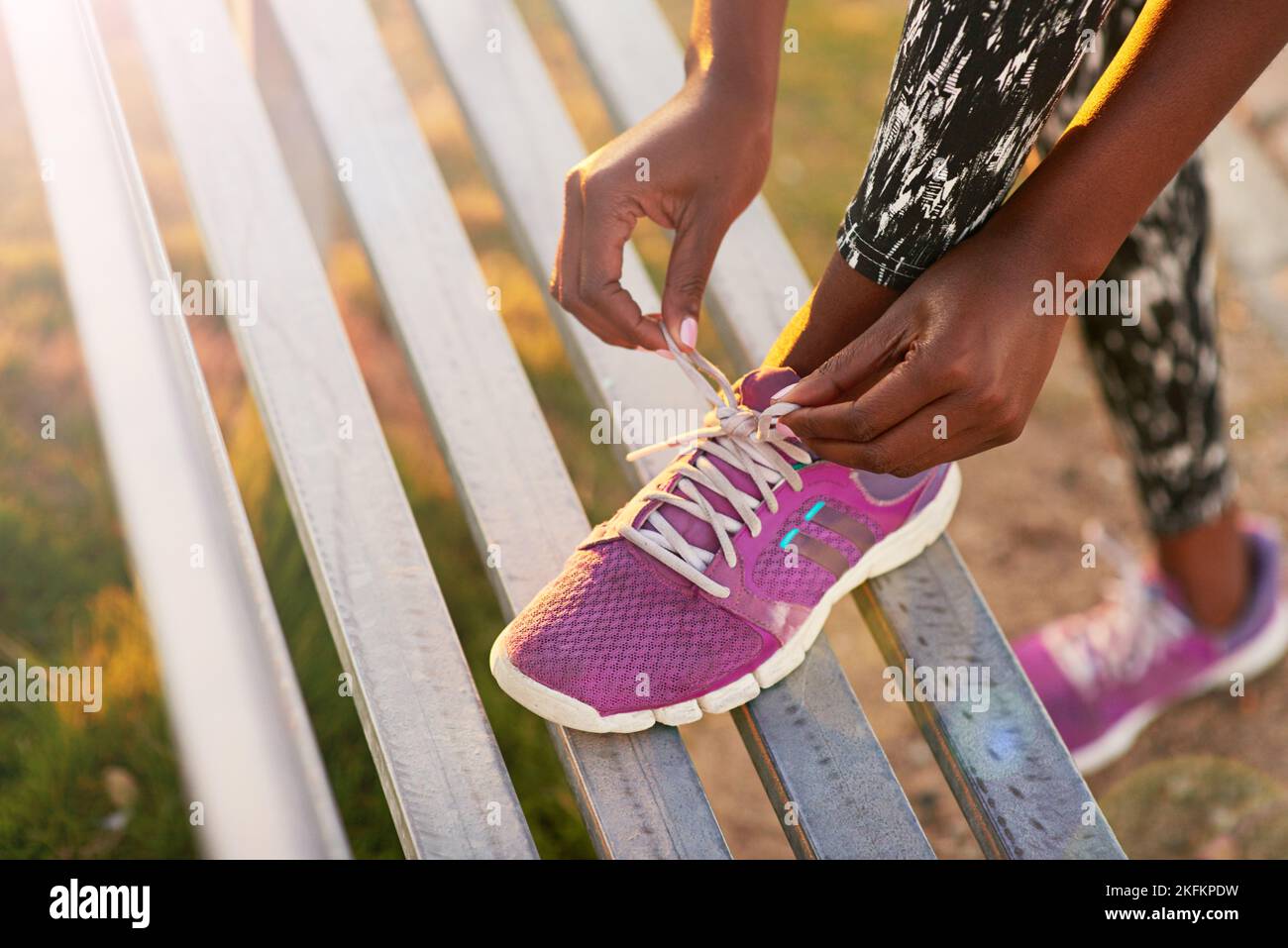 Put on your running shoes and lets race. Cropped image of a woman tying her shoelaces Stock ...