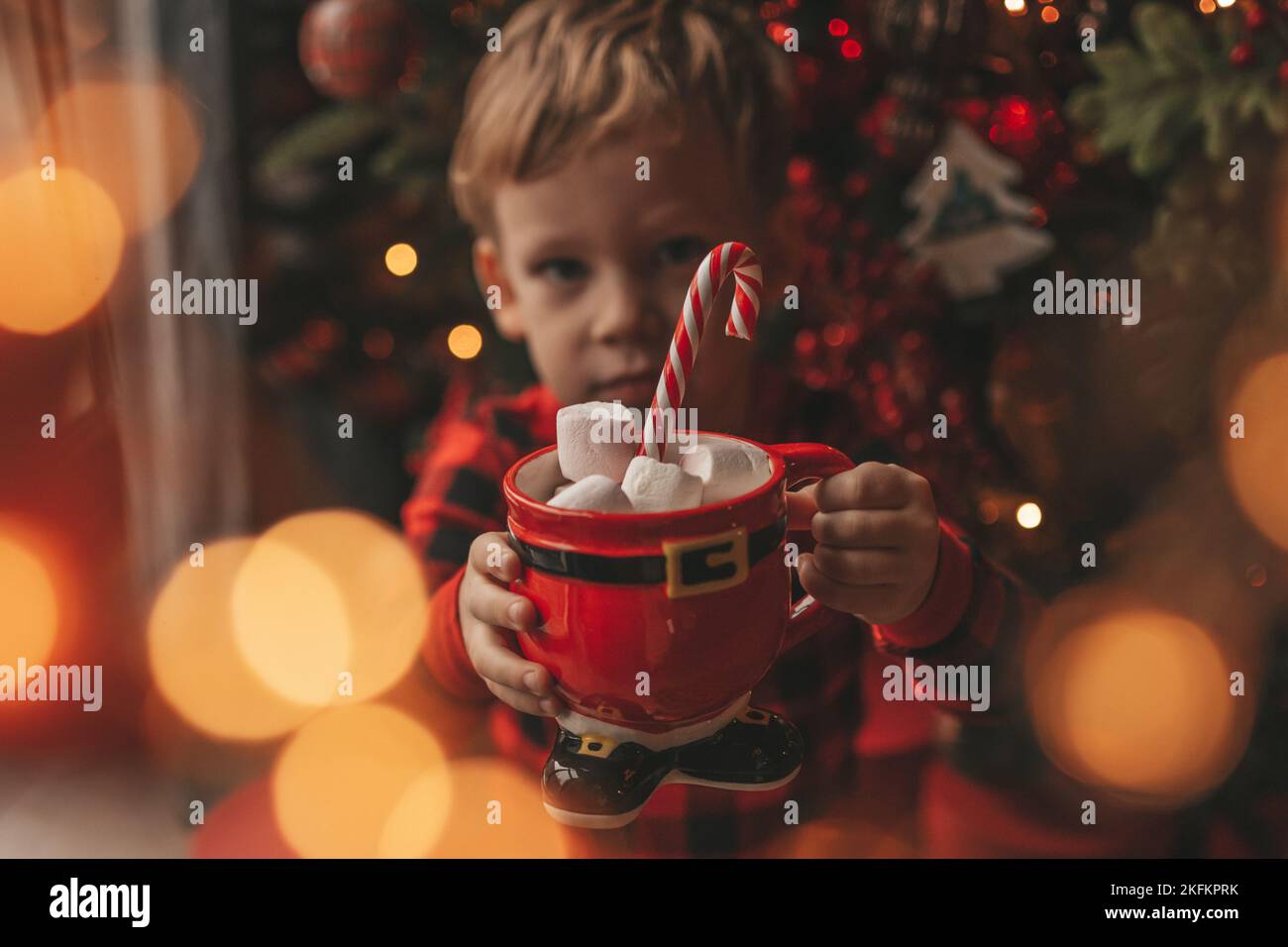 Happy little boy dreamer waiting at miracle Santa enjoy sweets color ...