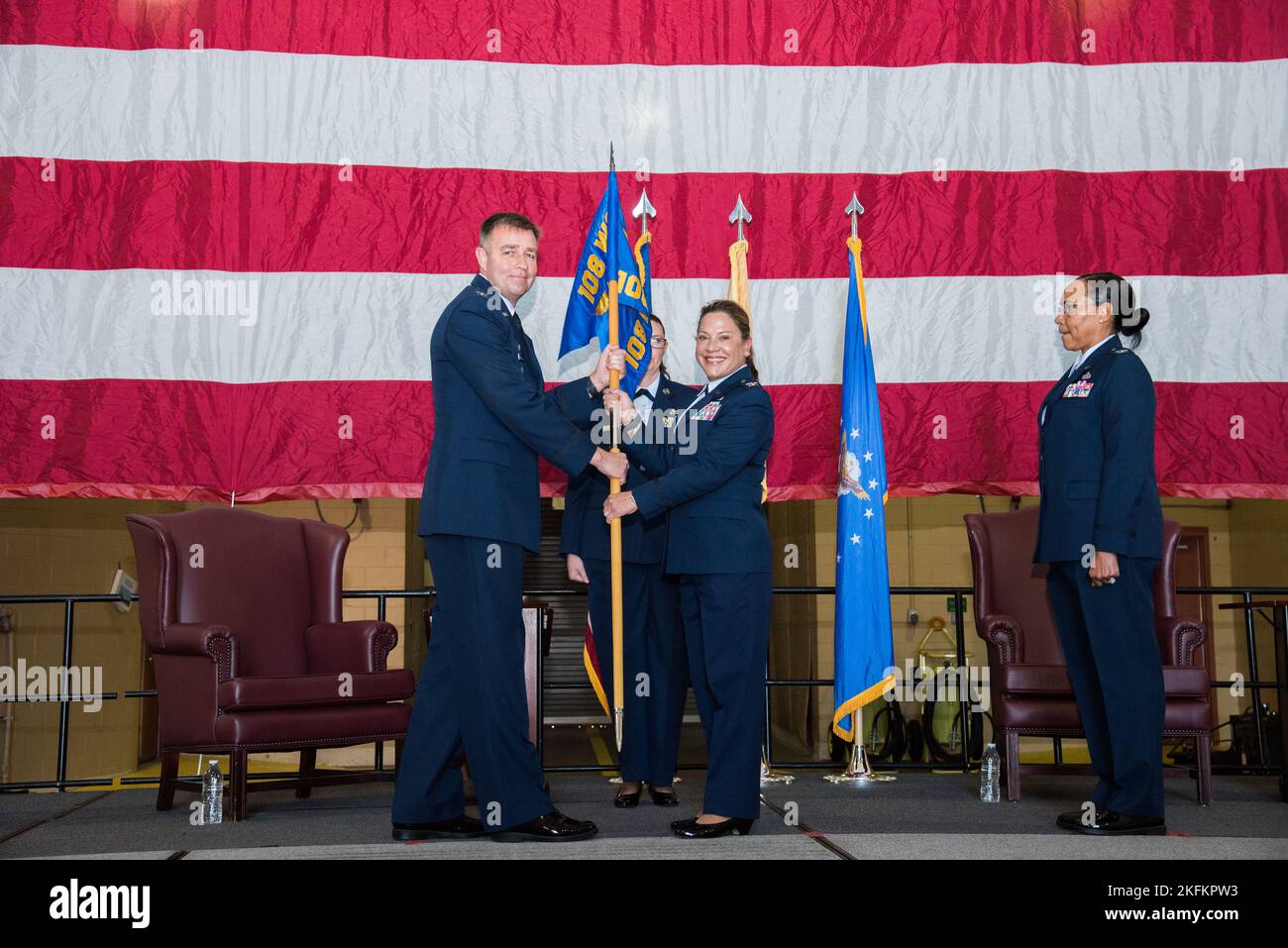 Col. Eric Guttormsen, 108th Wing commander, left, receives the guidon ...